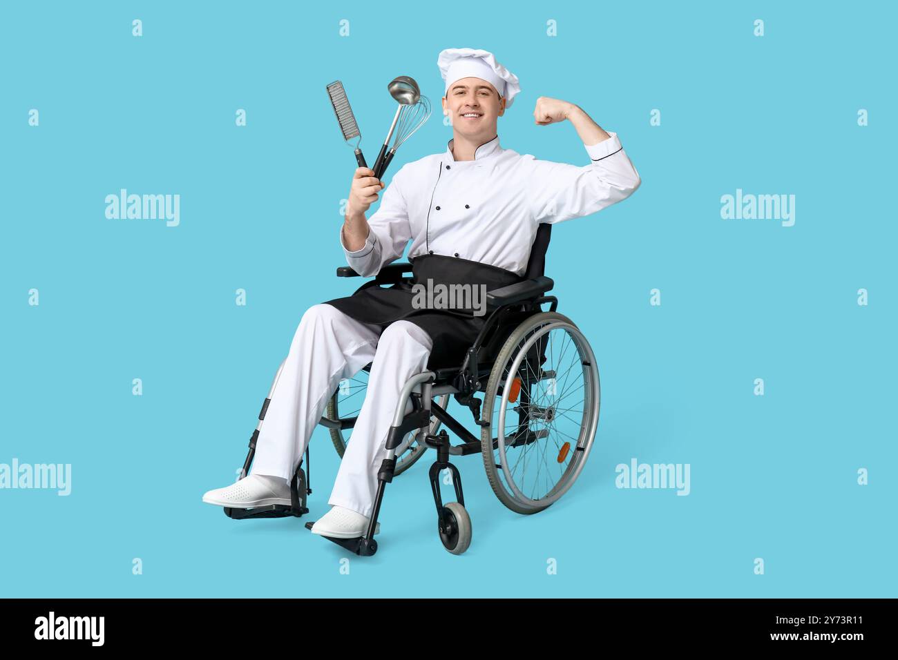 Male chef in wheelchair with kitchen utensils on blue background Stock ...