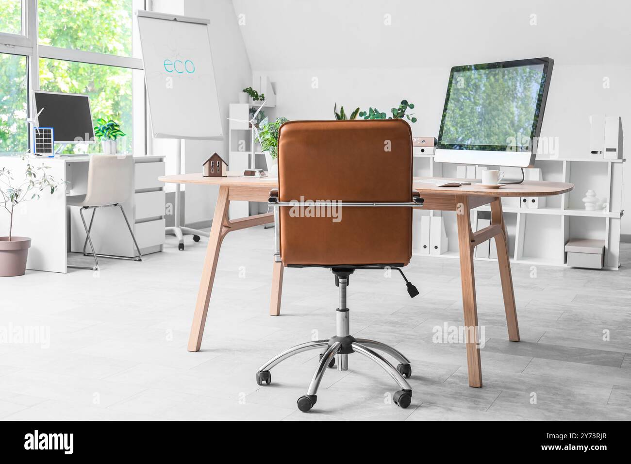 Interior of engineer's office with desks and wind turbine models Stock ...