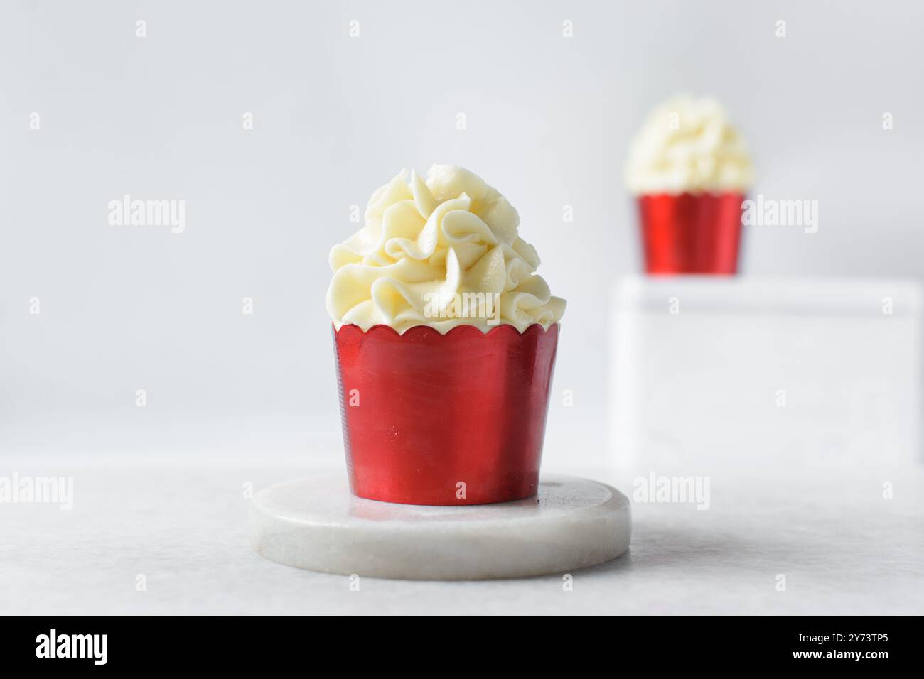 red cupcakes with tall buttercream swirl, cupcakes in red foil liners ...