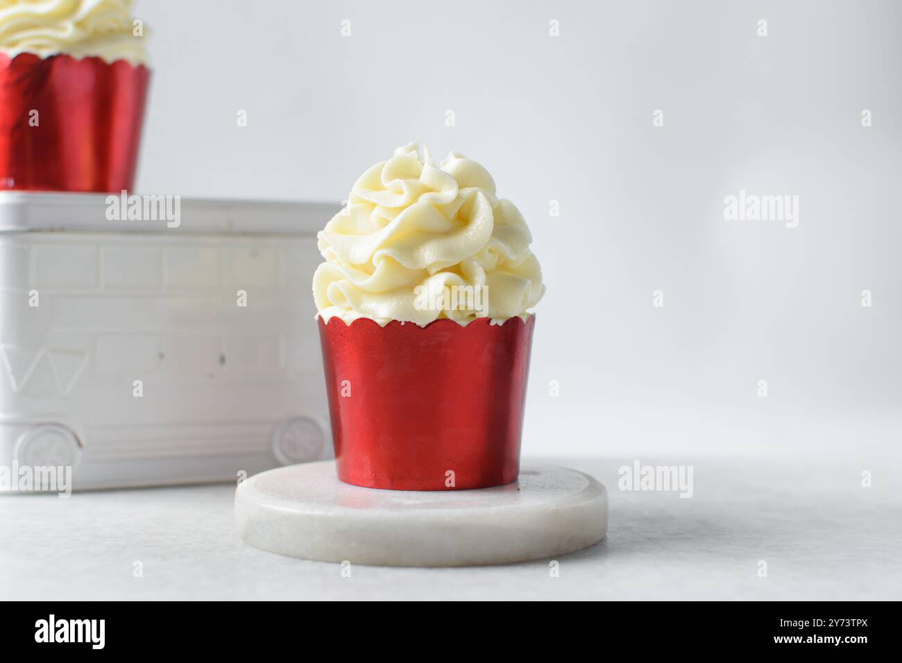 red cupcakes with tall buttercream swirl, cupcakes in red foil liners ...