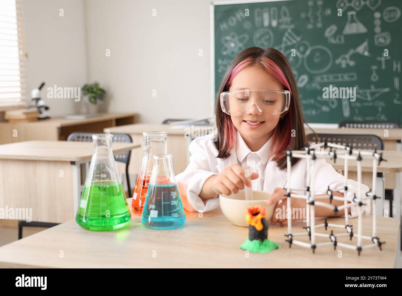 Cute little girl studying chemistry in science classroom Stock Photo ...