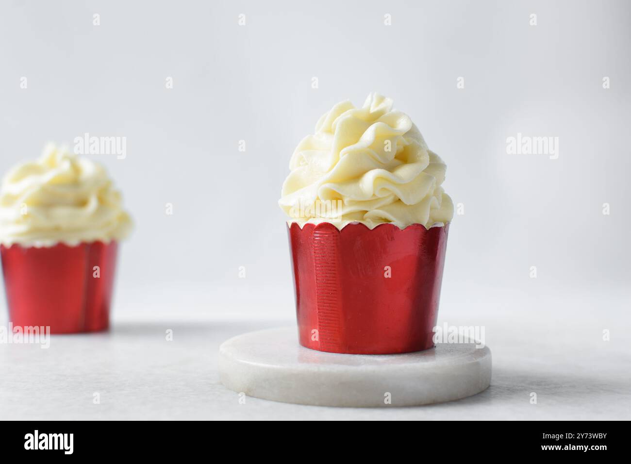 red cupcakes with tall buttercream swirl, cupcakes in red foil liners ...