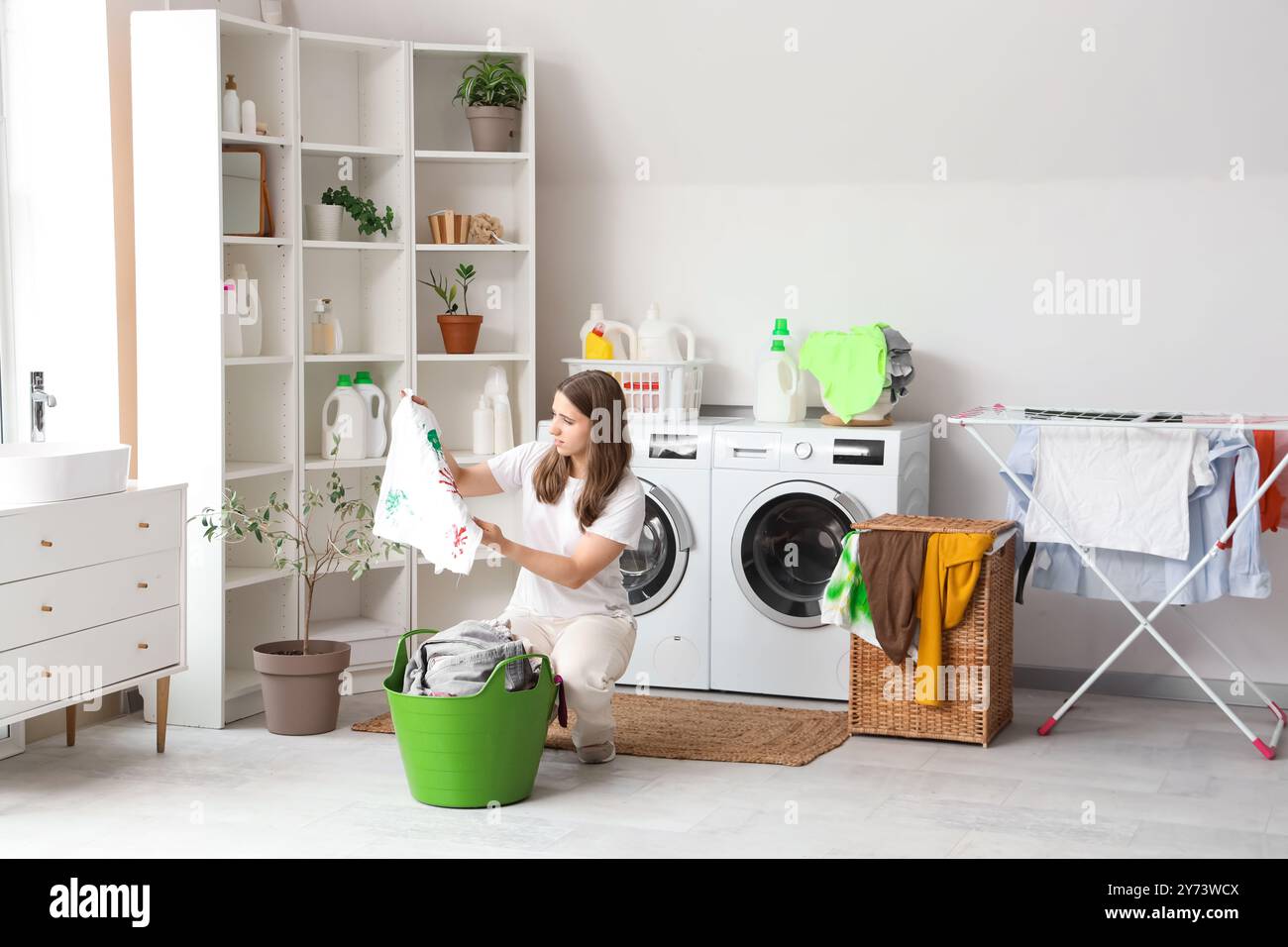 Woman sorting laundry washing machine hi-res stock photography and ...