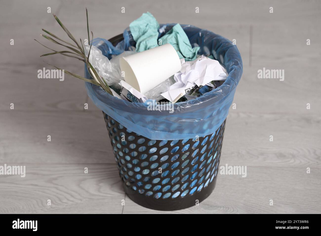 Trash bin full of garbage in kitchen Stock Photo - Alamy
