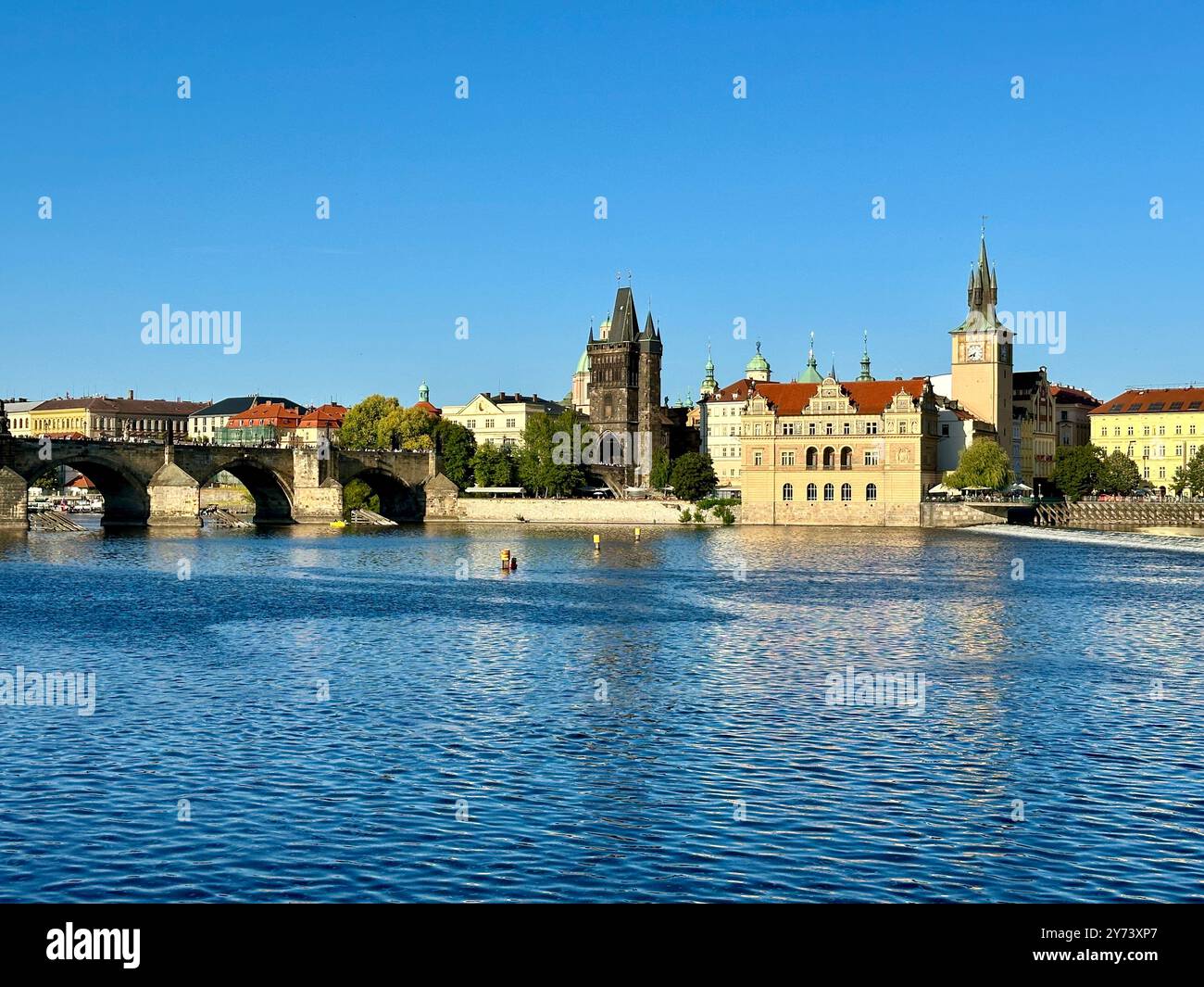 The photograph showcases a medieval European cityscape in summer ...