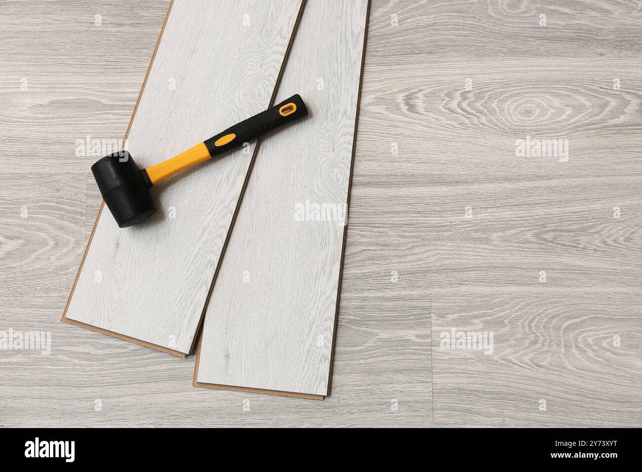 Mallet and laminate boards on floor Stock Photo - Alamy