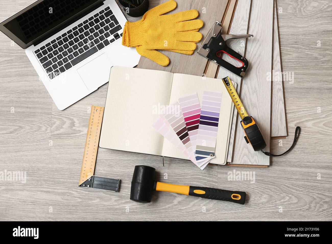 Tools, laptop, color palettes and laminate boards on floor Stock Photo ...