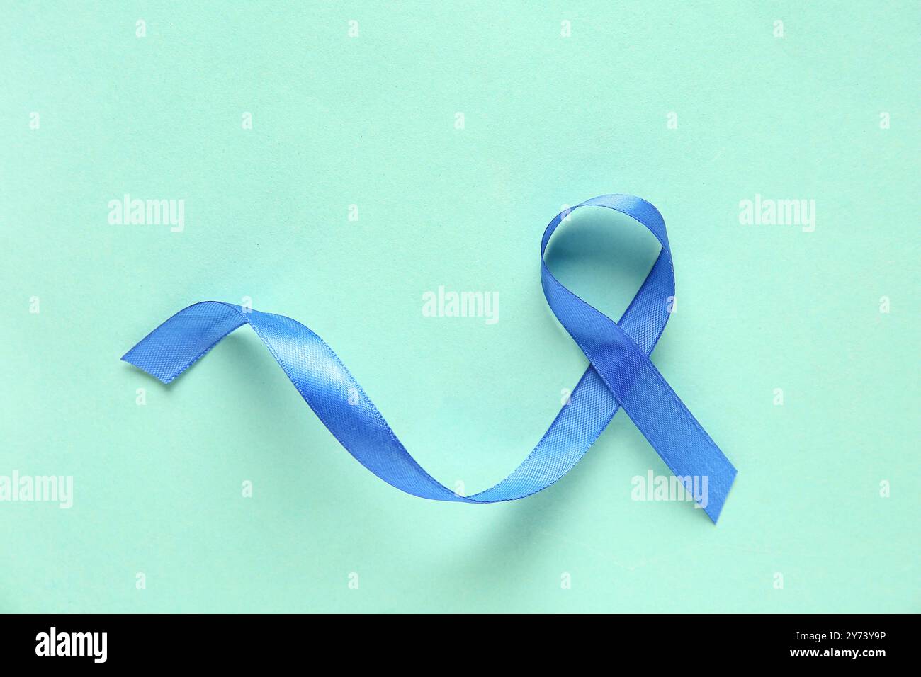 Blue ribbon on turquoise background. World Cancer Day Stock Photo - Alamy