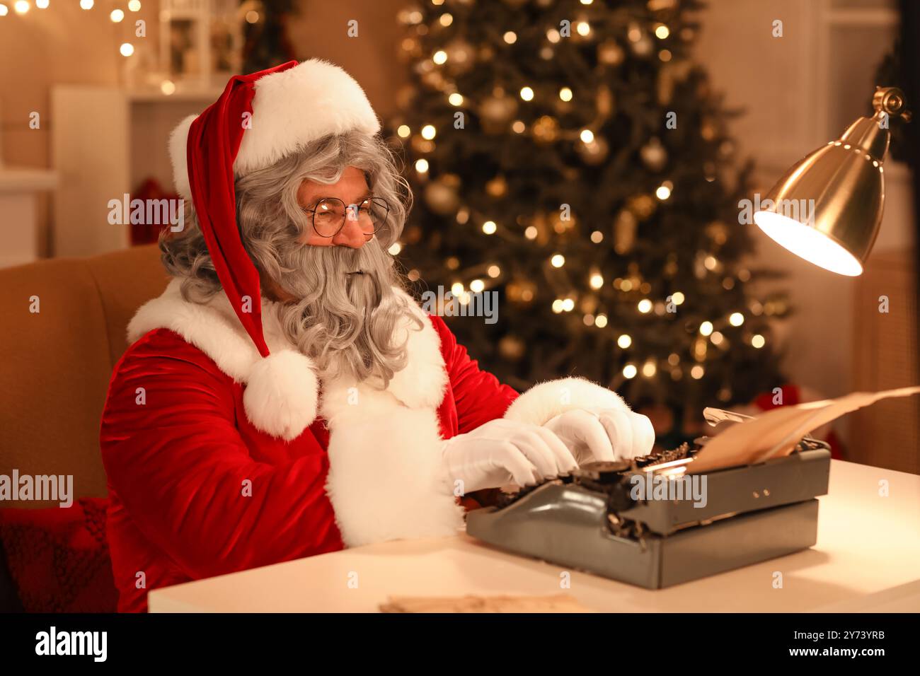 Santa Claus with typewriter writing Christmas story at night Stock ...