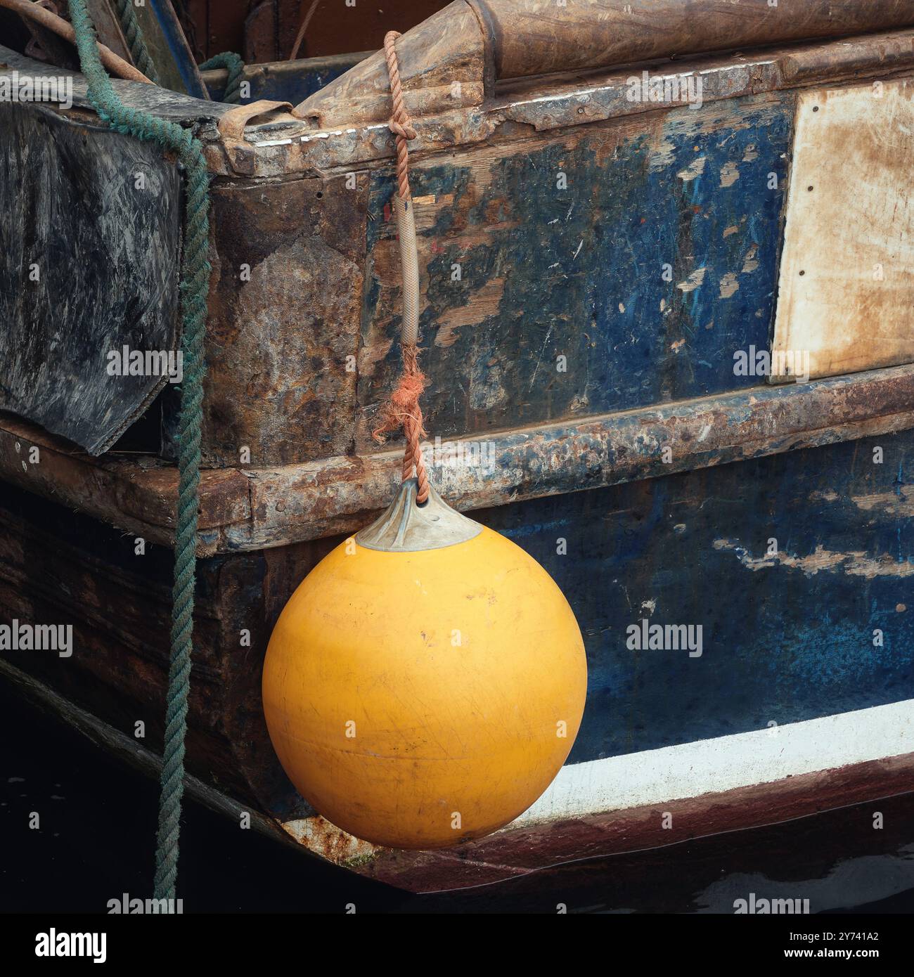 Round yellow mooring buoy fender aboard an old boat boat yacht. Isle of ...