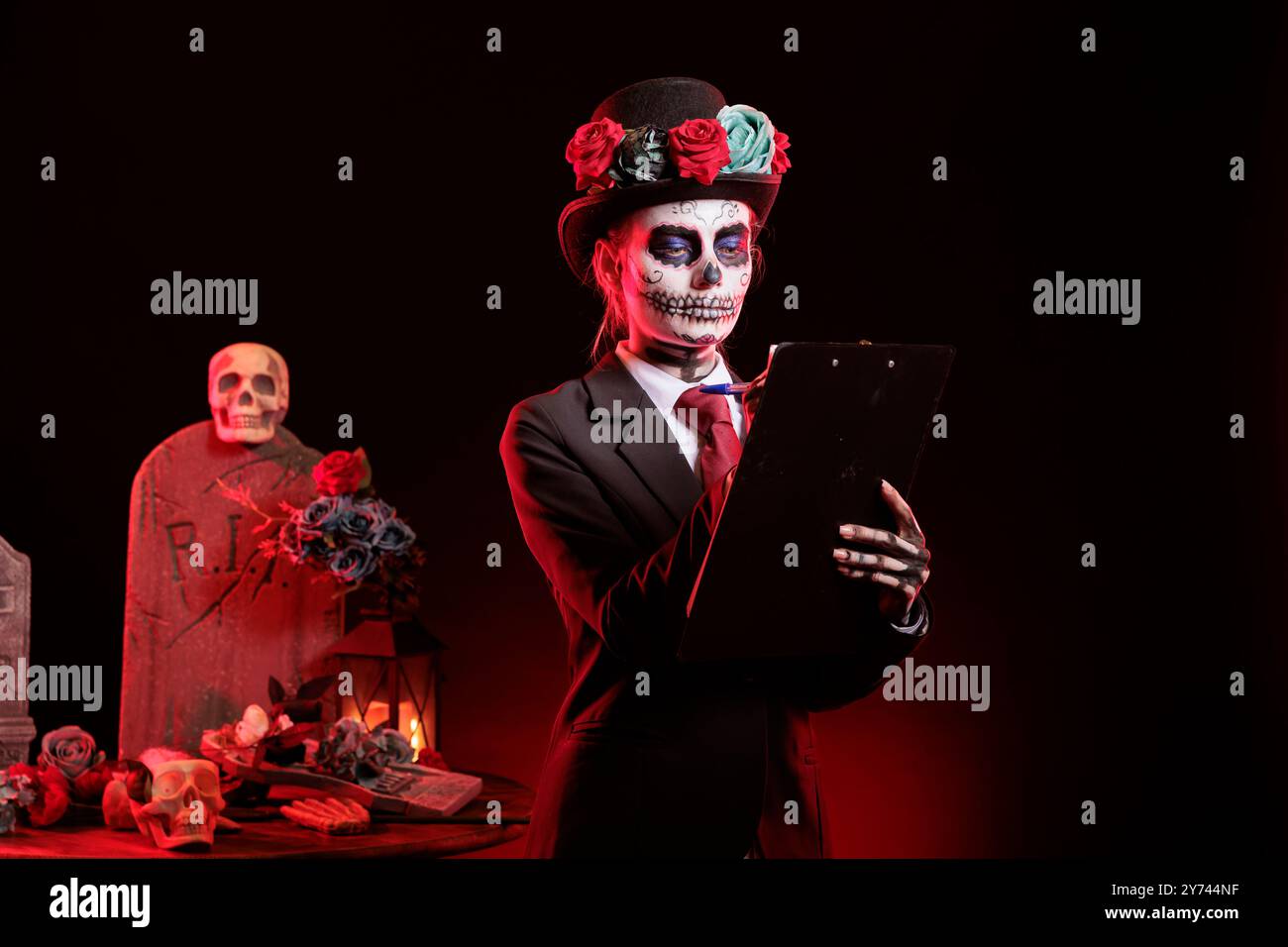 Woman holding clipboard, checking documents, in graveyard, celebrating ...