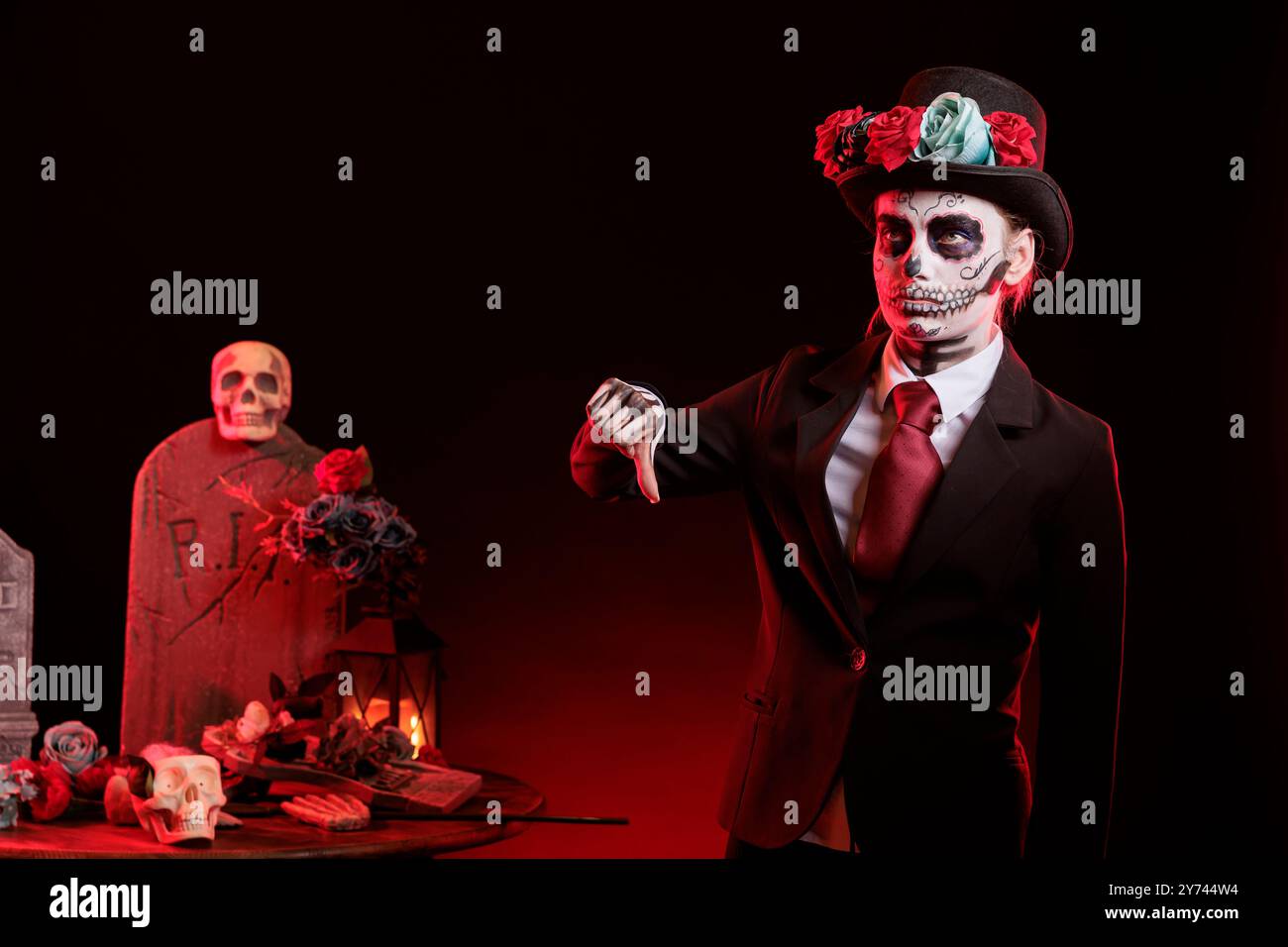 Upset woman does thumbs down sign in graveyard while celebrating Day of ...