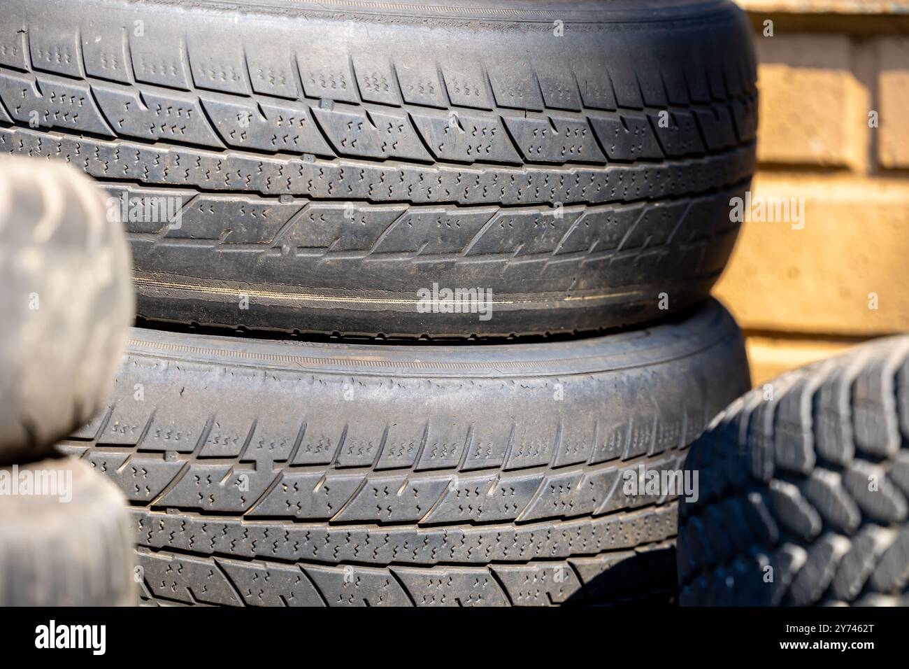 Worn and damaged tread of old tires lying in a landfill. Decreased road ...