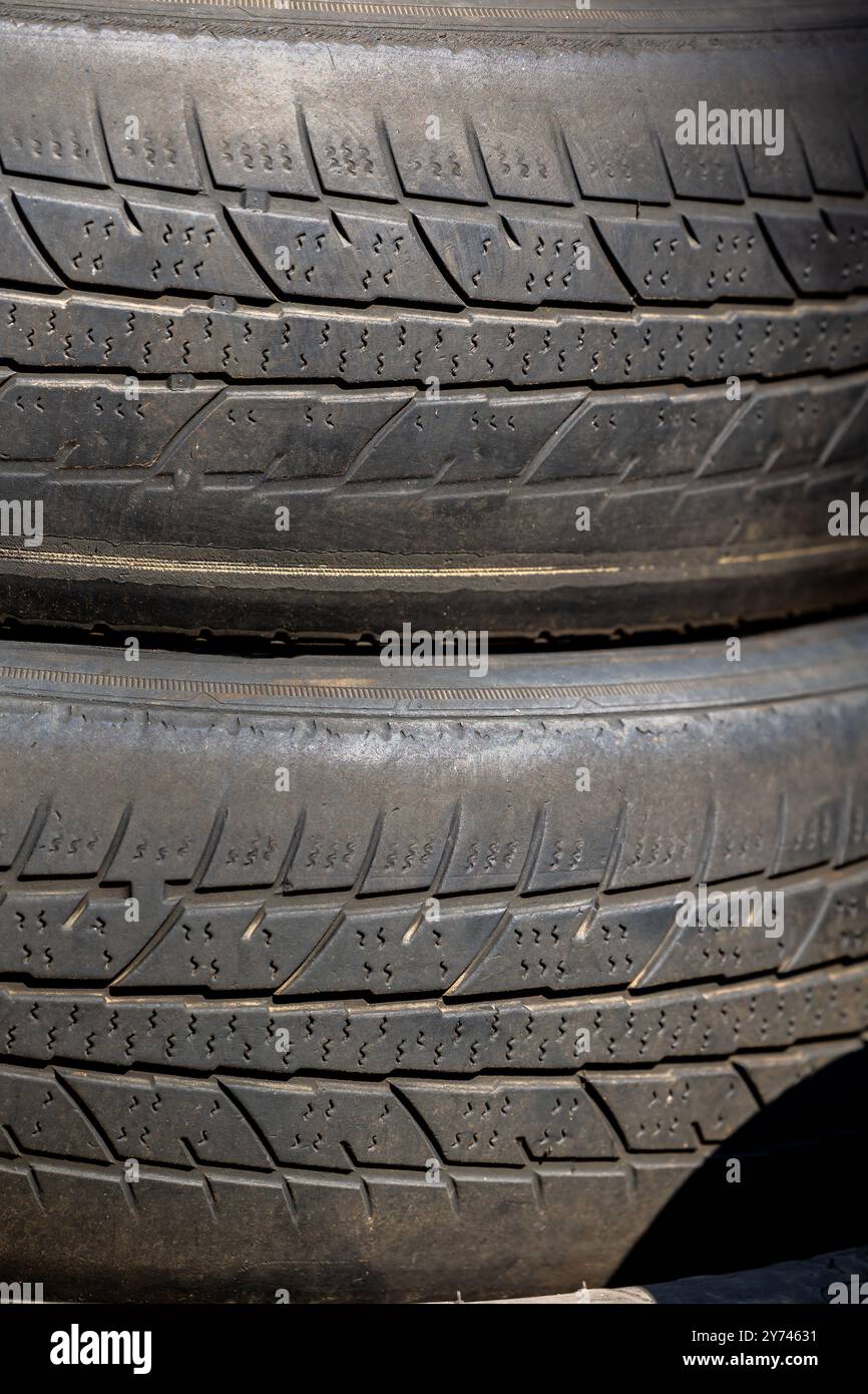 Worn and damaged tread of old tires lying in a landfill. Decreased road ...