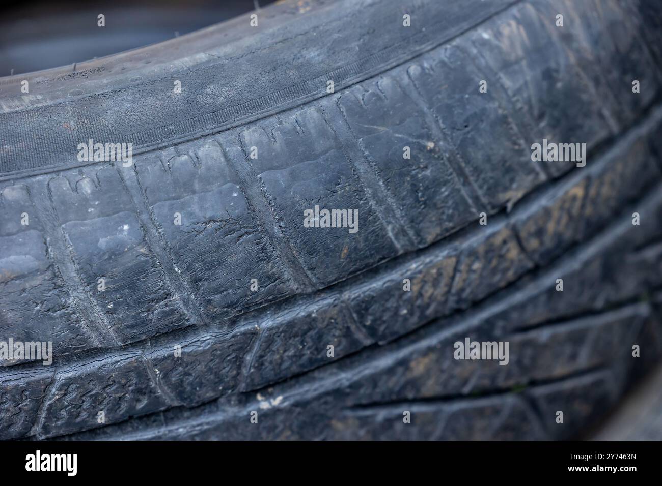 Worn and damaged tread of old tires lying in a landfill. Decreased road ...