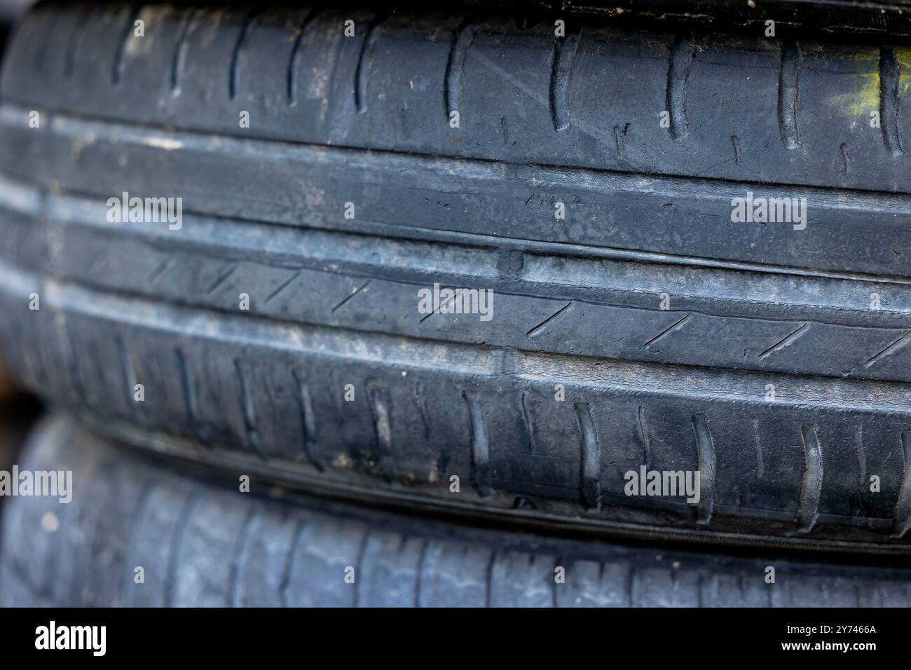 Worn and damaged tread of old tires lying in a landfill. Decreased road ...