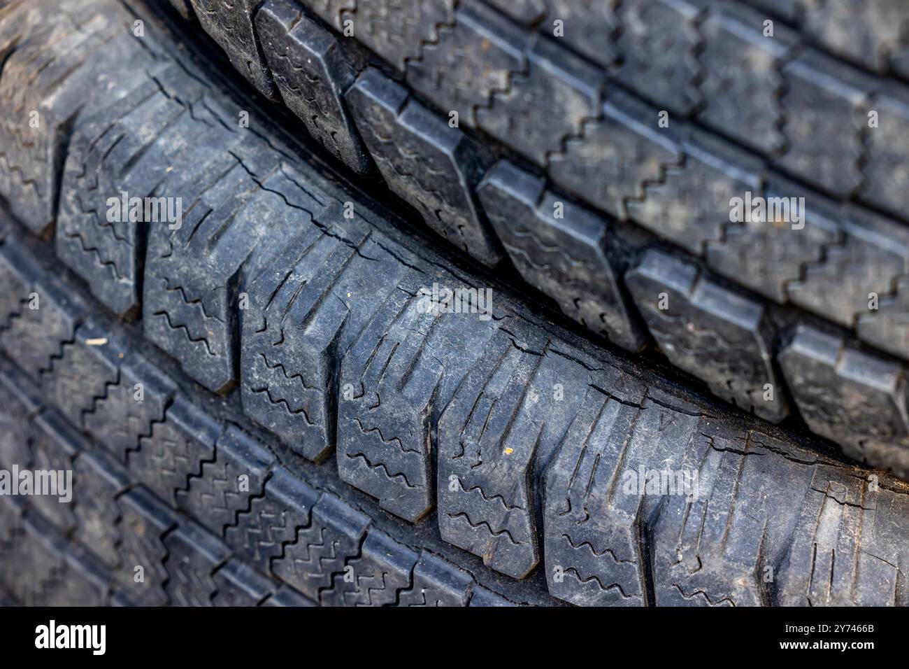 Worn and damaged tread of old tires lying in a landfill. Decreased road ...