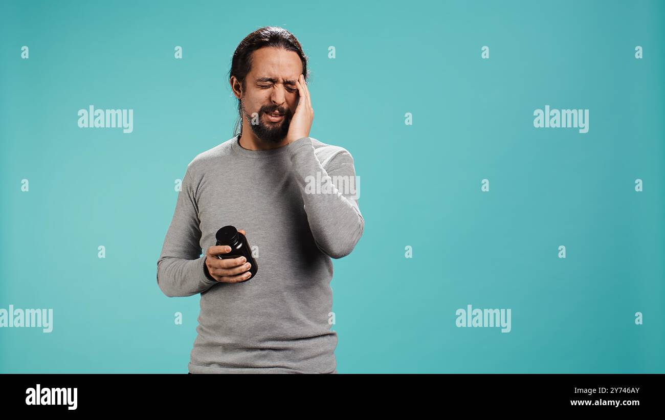 Man suffering from painful headache, taking aspirin to cure illness ...