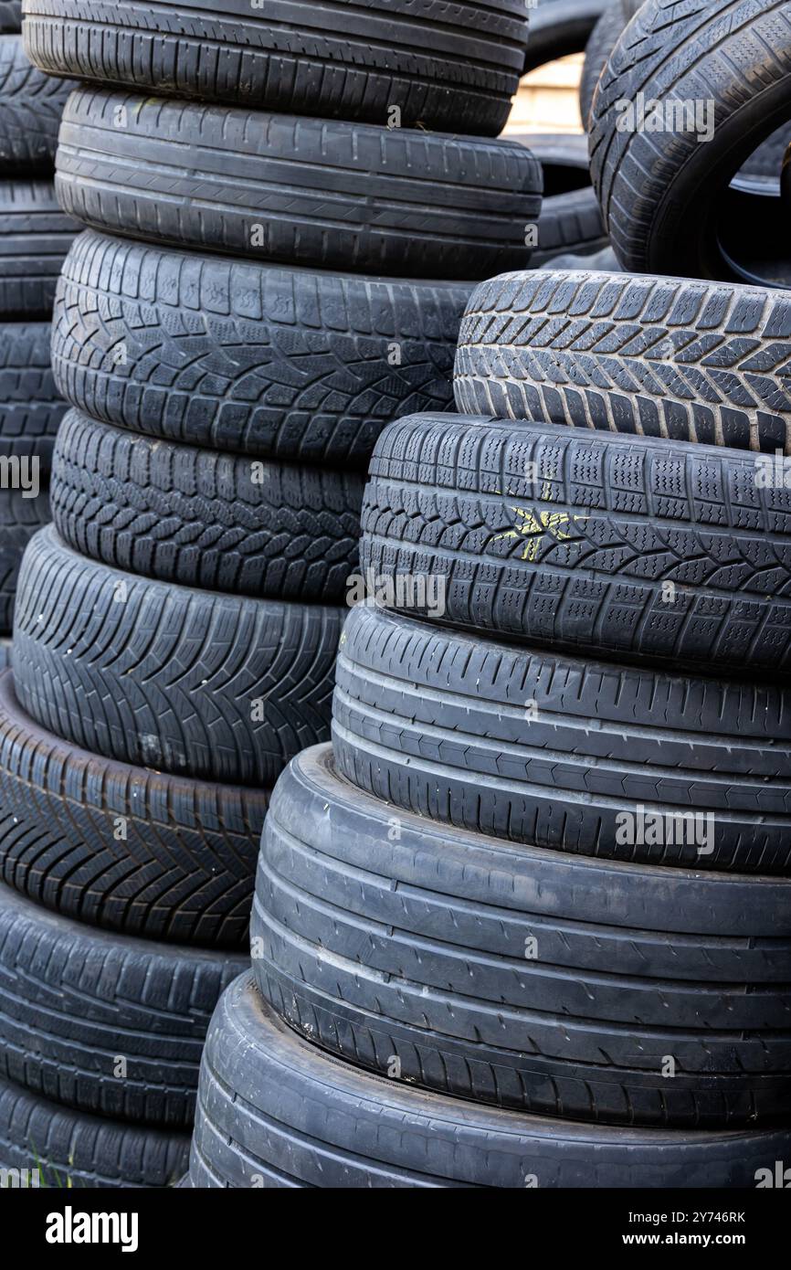 Stack of old, worn and damaged tires lying in a landfill. Decreased ...
