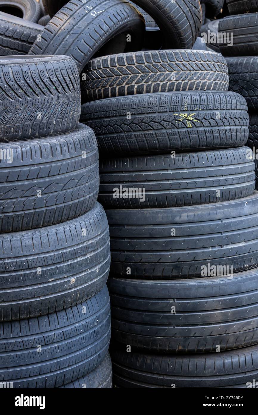 Stack of old, worn and damaged tires lying in a landfill. Decreased ...