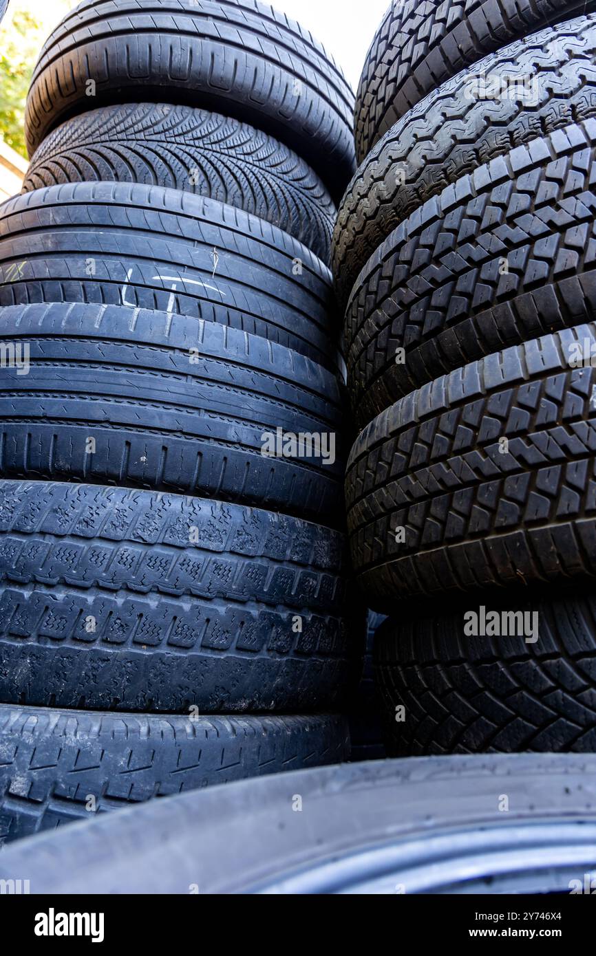 Stack of old, worn and damaged tires lying in a landfill. Decreased ...
