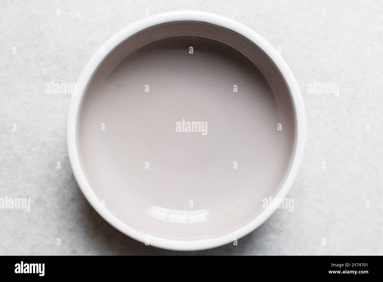 Top view of grey ceramic plates on a marble table, grey taupe ceramic ...