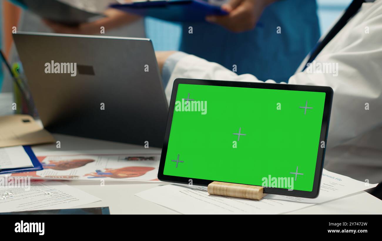 Licensed doctor and his staff review x ray scan results next to ...