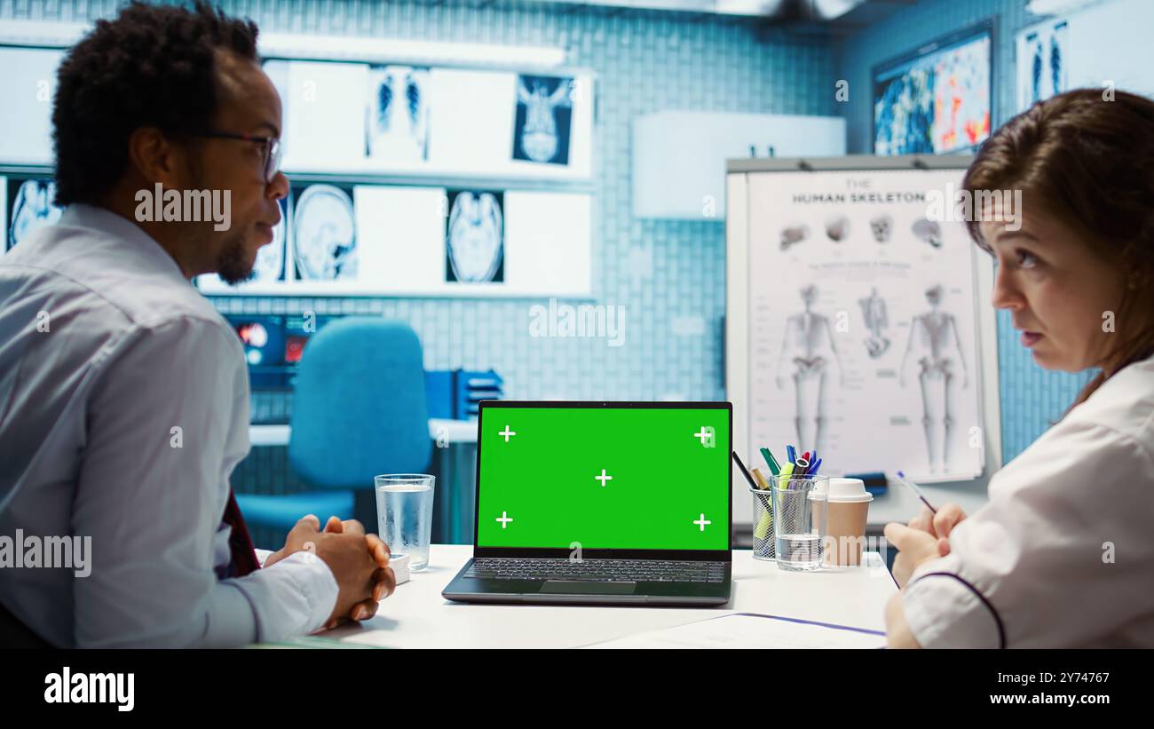 Medical expert pointing at isolated chroma key display in cabinet ...