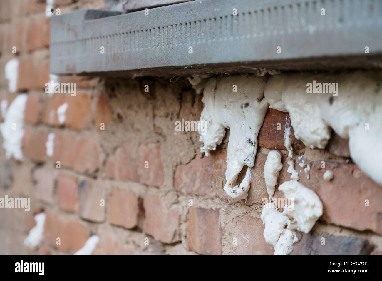 Textured Close-Up of Brick Wall with Expanding Foam Application Stock ...