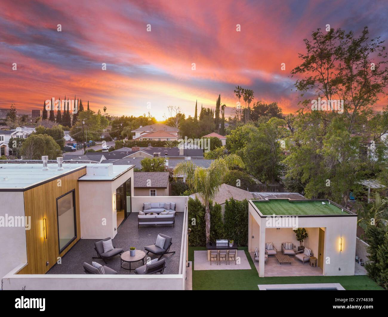 Aerial view of a modern house with rooftop terrace and backyard patio ...