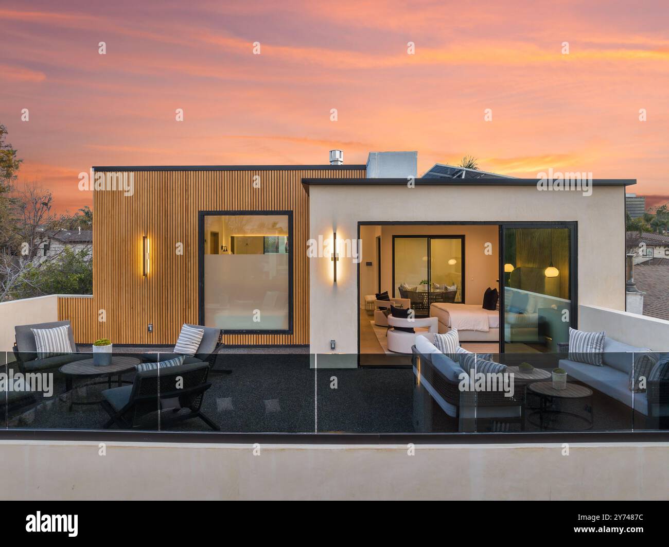 Modern rooftop patio with stylish furniture and sunset view, featuring ...