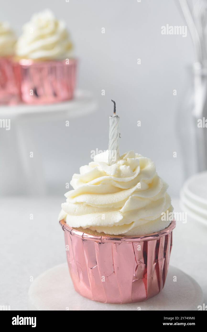 Pink cupcakes with tall buttercream swirl with a candle, cupcakes in ...