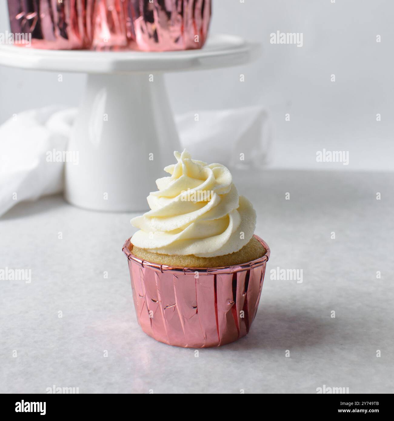 Pink cupcakes with tall buttercream swirl, cupcakes in pink foil liners ...