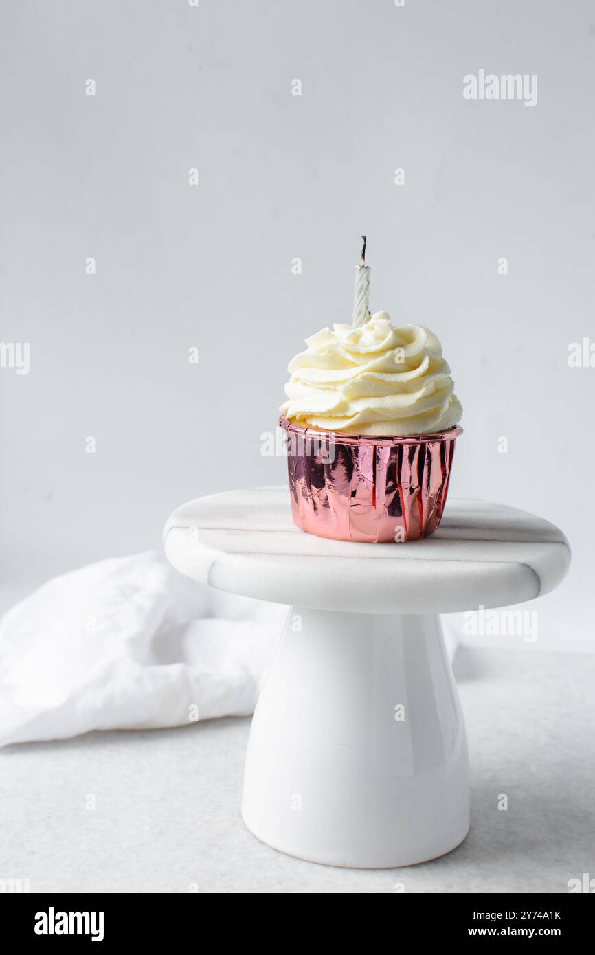 Pink cupcakes with tall buttercream swirl with a candle, cupcakes in ...