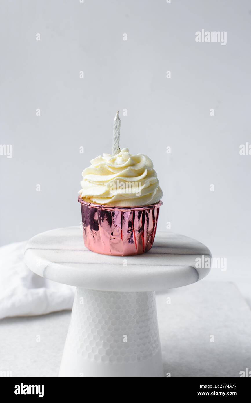 Pink cupcakes with tall buttercream swirl with a candle, cupcakes in ...