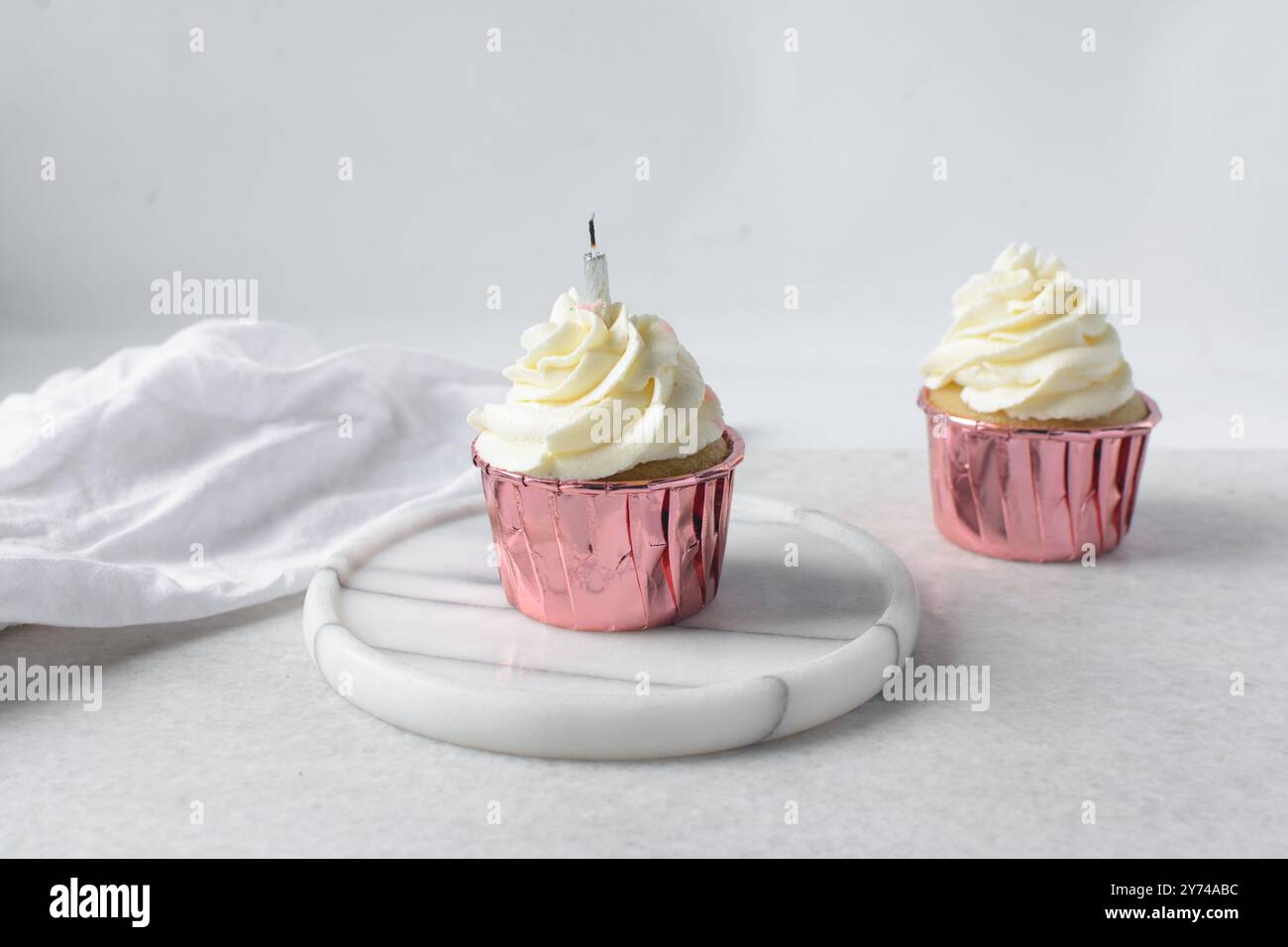 Pink cupcakes with tall buttercream swirl with a candle, cupcakes in ...