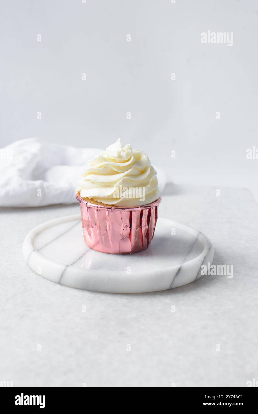 Pink cupcakes with tall buttercream swirl, cupcakes in pink foil liners ...