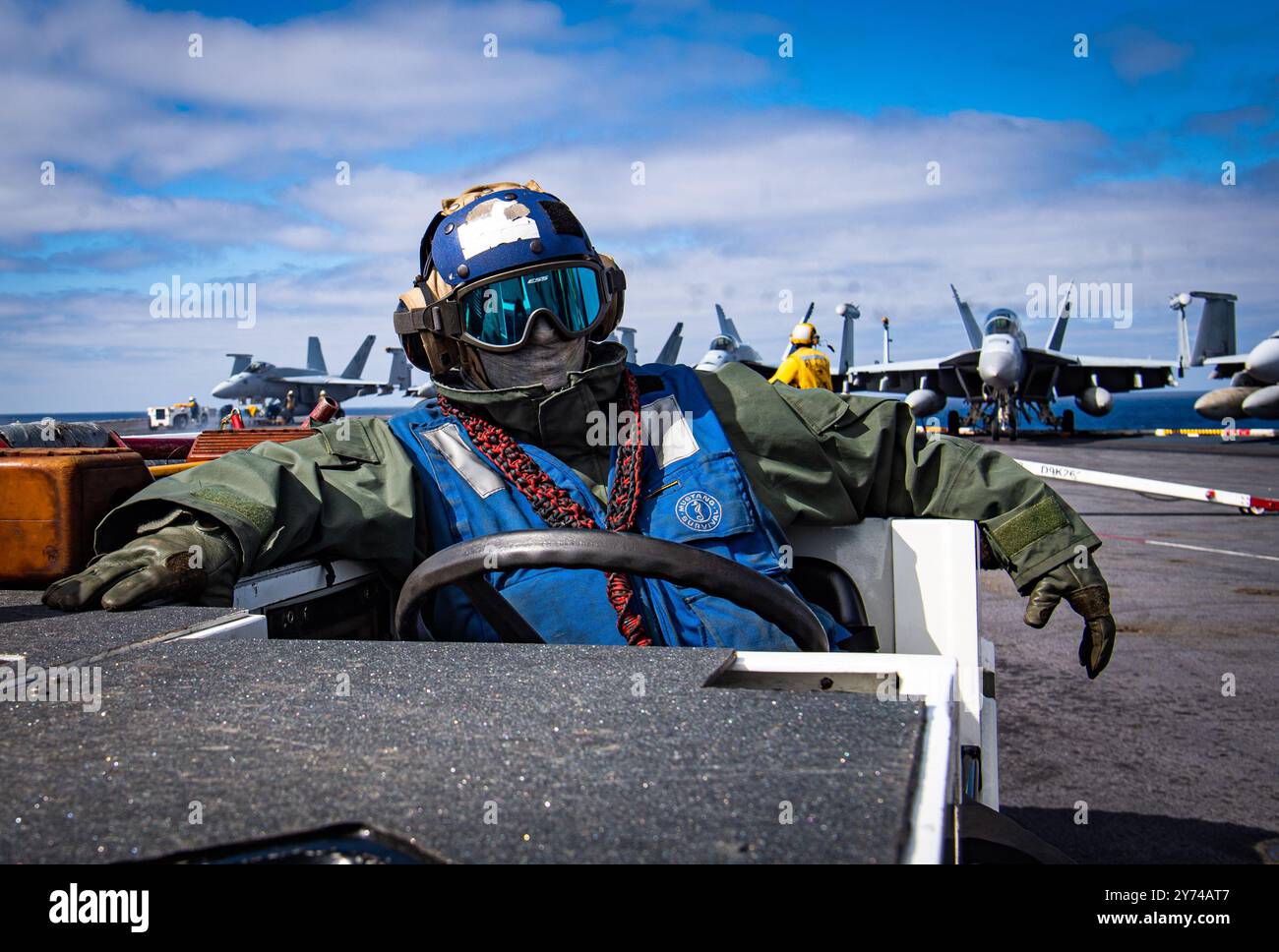 A Sailor observes flight operations on the flight deck of the aircraft ...