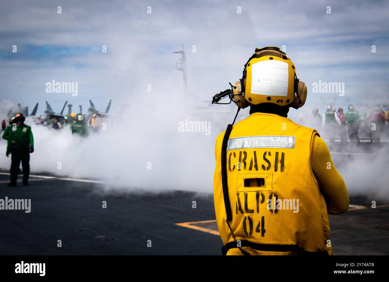 A Sailor observes flight operations on the flight deck of the aircraft ...