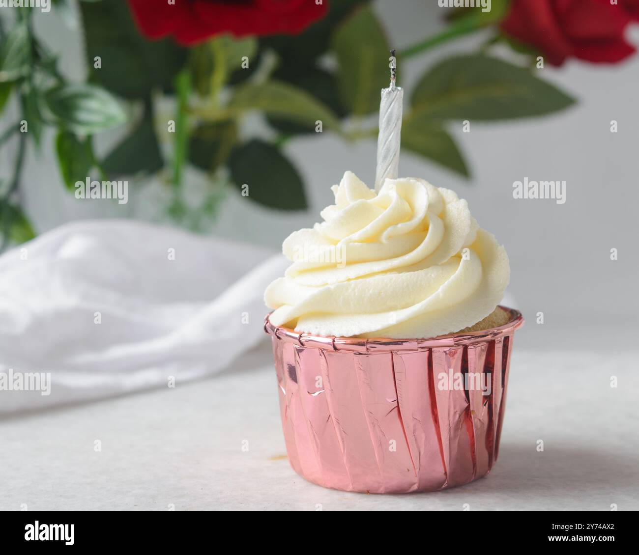 Pink cupcakes with tall buttercream swirl with a candle, cupcakes in ...