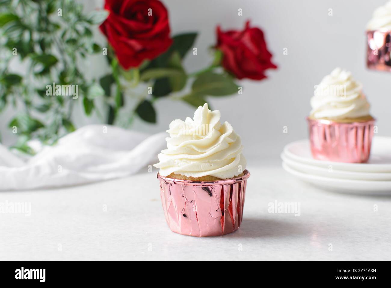 Pink cupcakes with tall buttercream swirl, cupcakes in pink foil liners ...