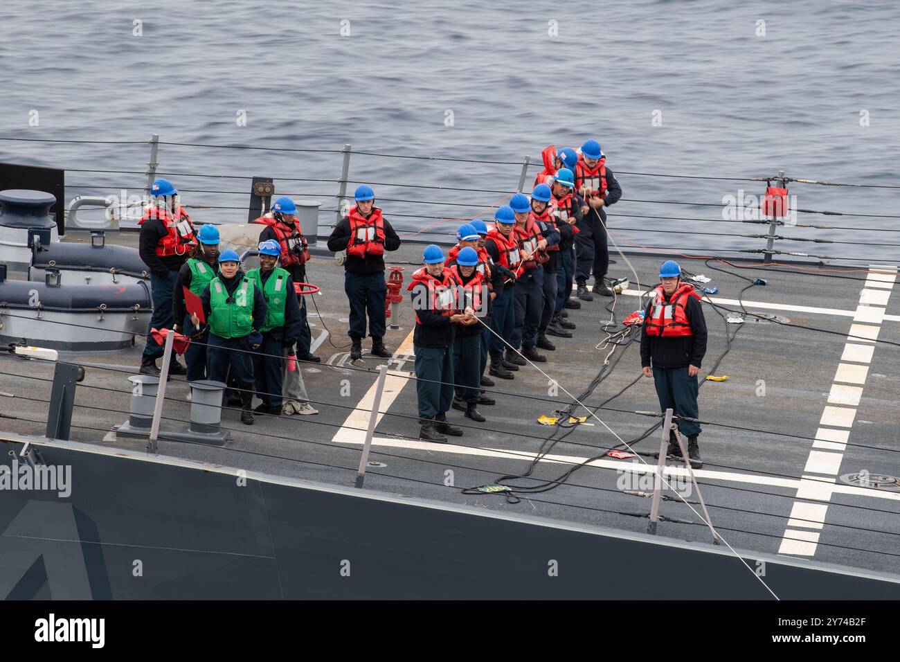 Sailors heave line aboard the Arleigh-Burke class guided missile ...