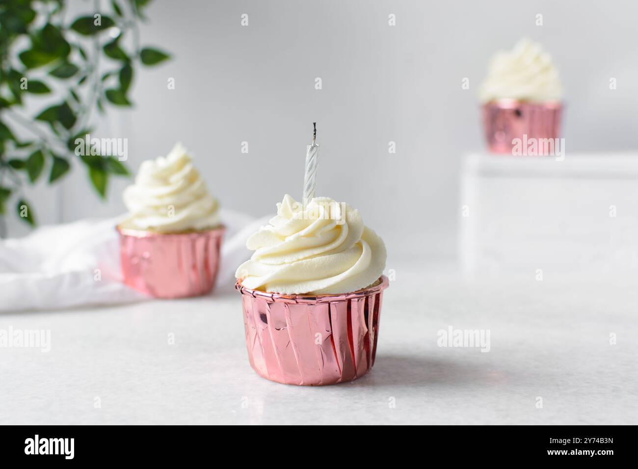 Pink cupcakes with tall buttercream swirl with a candle, cupcakes in ...