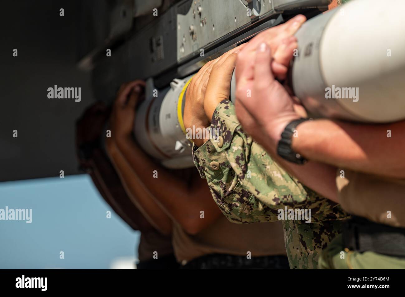 U.S. Sailors load an AIM-120D advanced medium-range air-to-air training ...