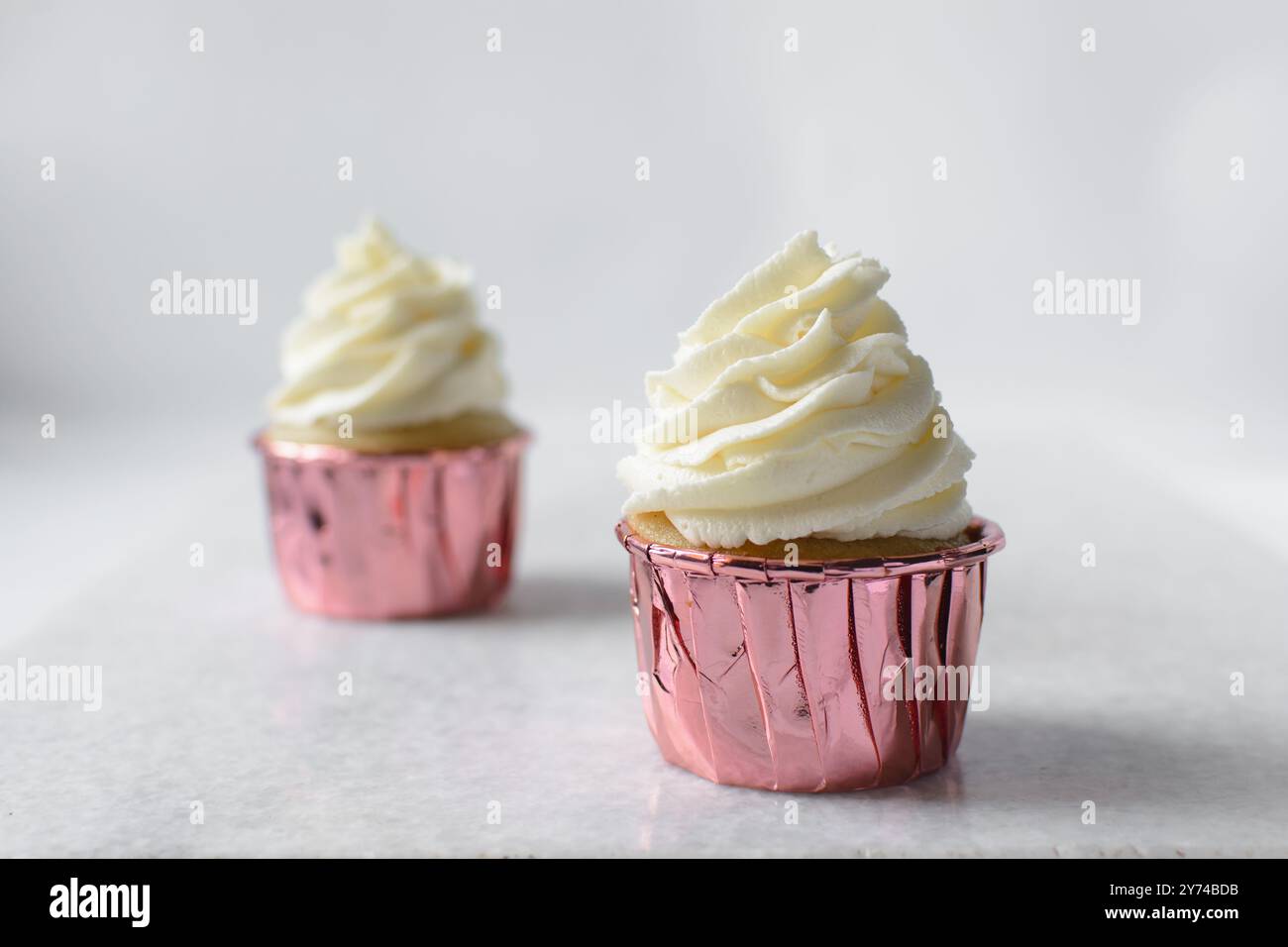 Pink cupcakes with tall buttercream swirl, cupcakes in pink foil liners ...