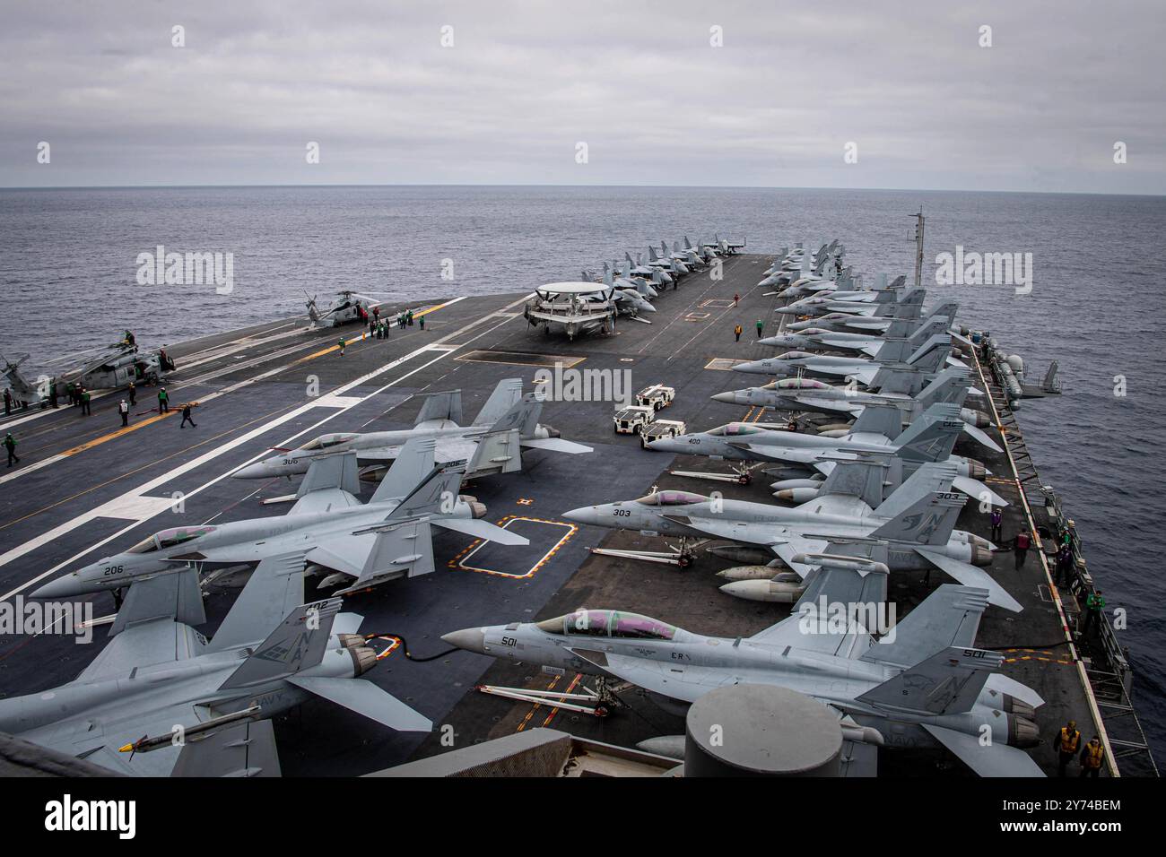 Aircraft rest on the flight deck of the aircraft carrier USS Nimitz ...