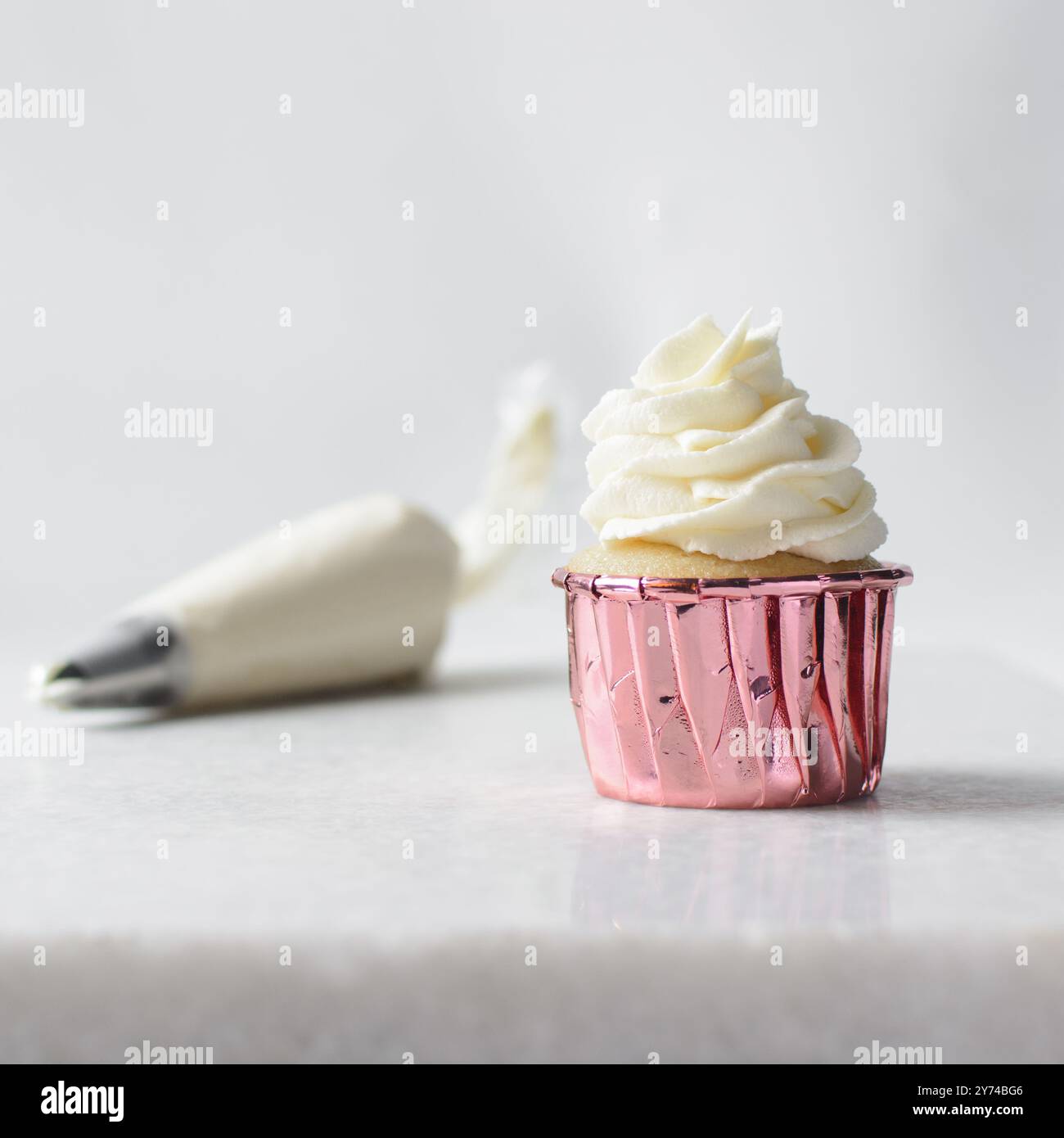 Pink cupcakes with tall buttercream swirl, cupcakes in pink foil liners ...
