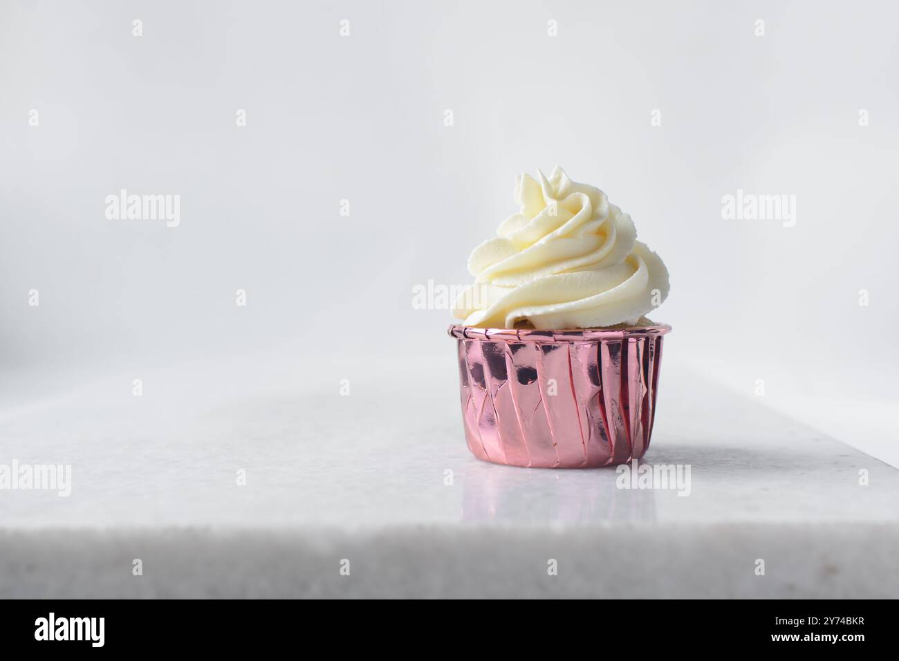 Pink cupcakes with tall buttercream swirl, cupcakes in pink foil liners ...