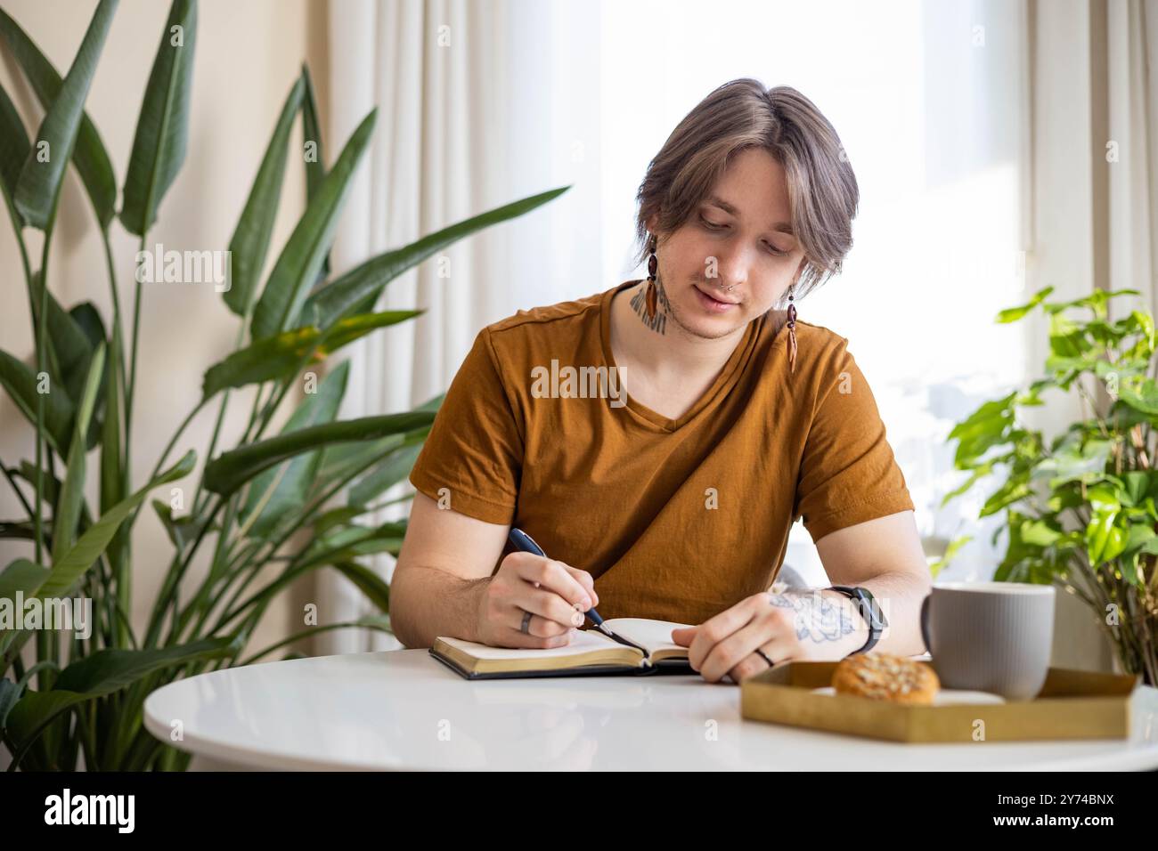 Stylish businessman writing in diary hi-res stock photography and ...