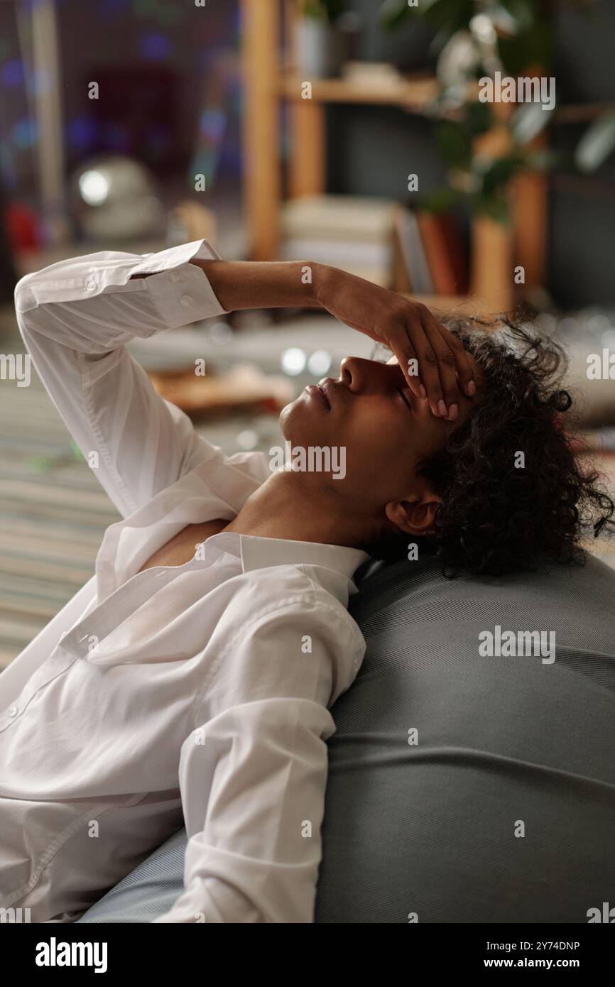 Teenage guy with splitting headache and other symptoms of hangover ...